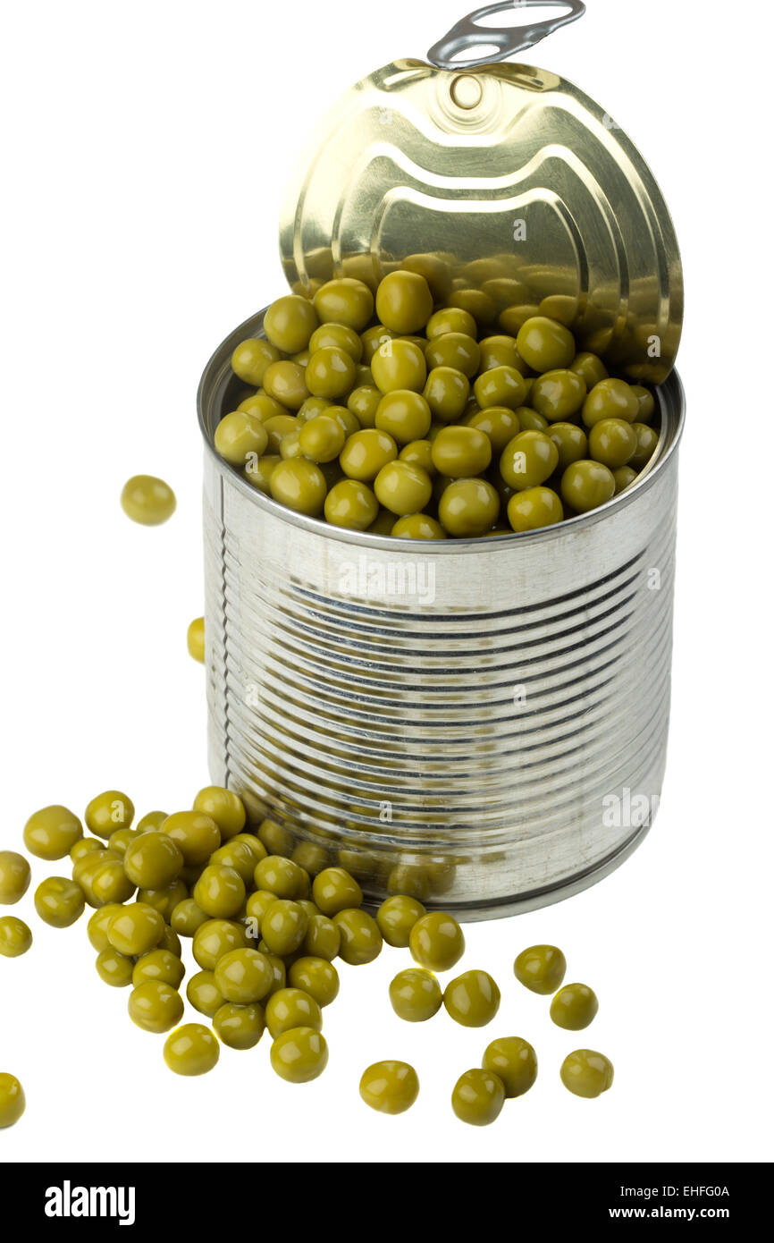 Opened tin with green peas and some spilled peas. Isolated on white ...