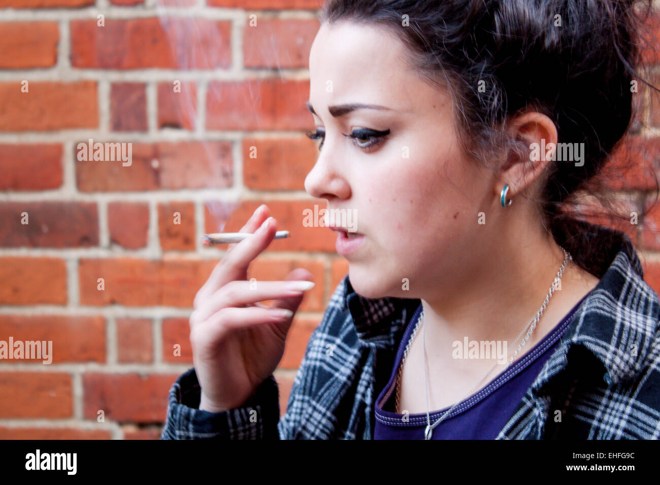 Girl smoking a joint model released Stock Photo - Alamy