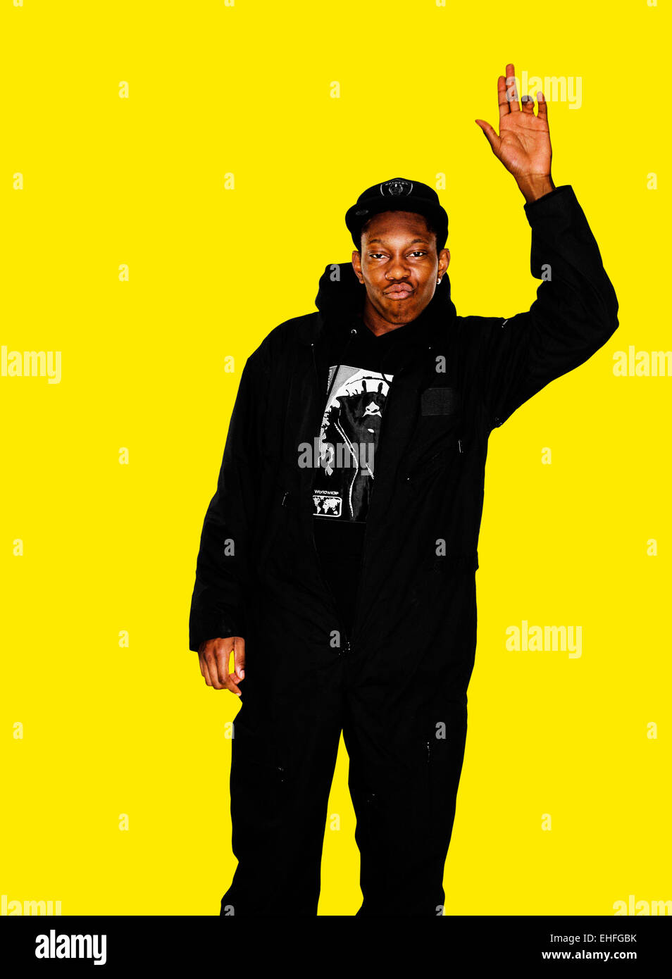Portrait of Dizzee Rascal against yellow background Stock Photo - Alamy
