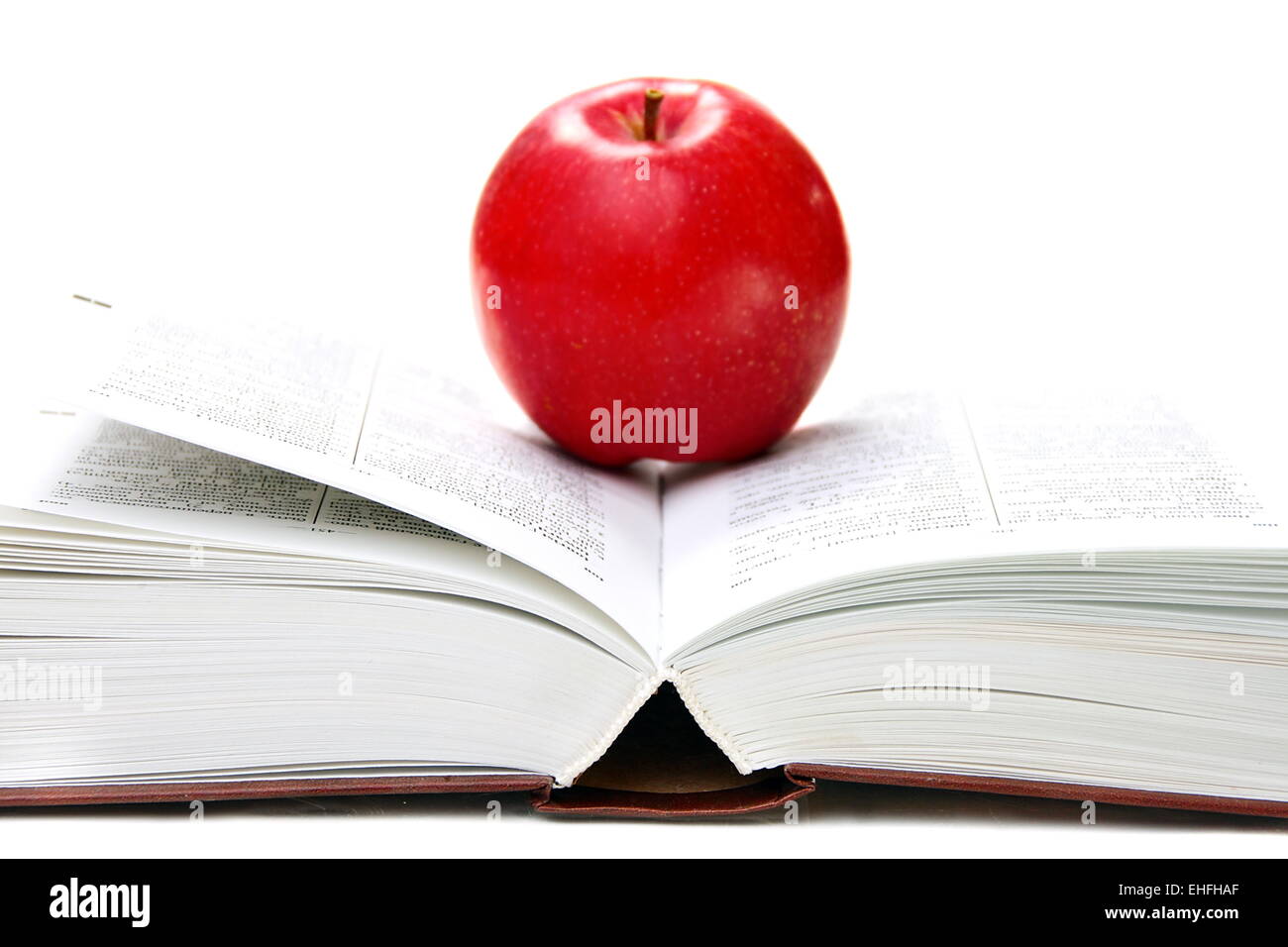 Red apple on an open book Stock Photo - Alamy