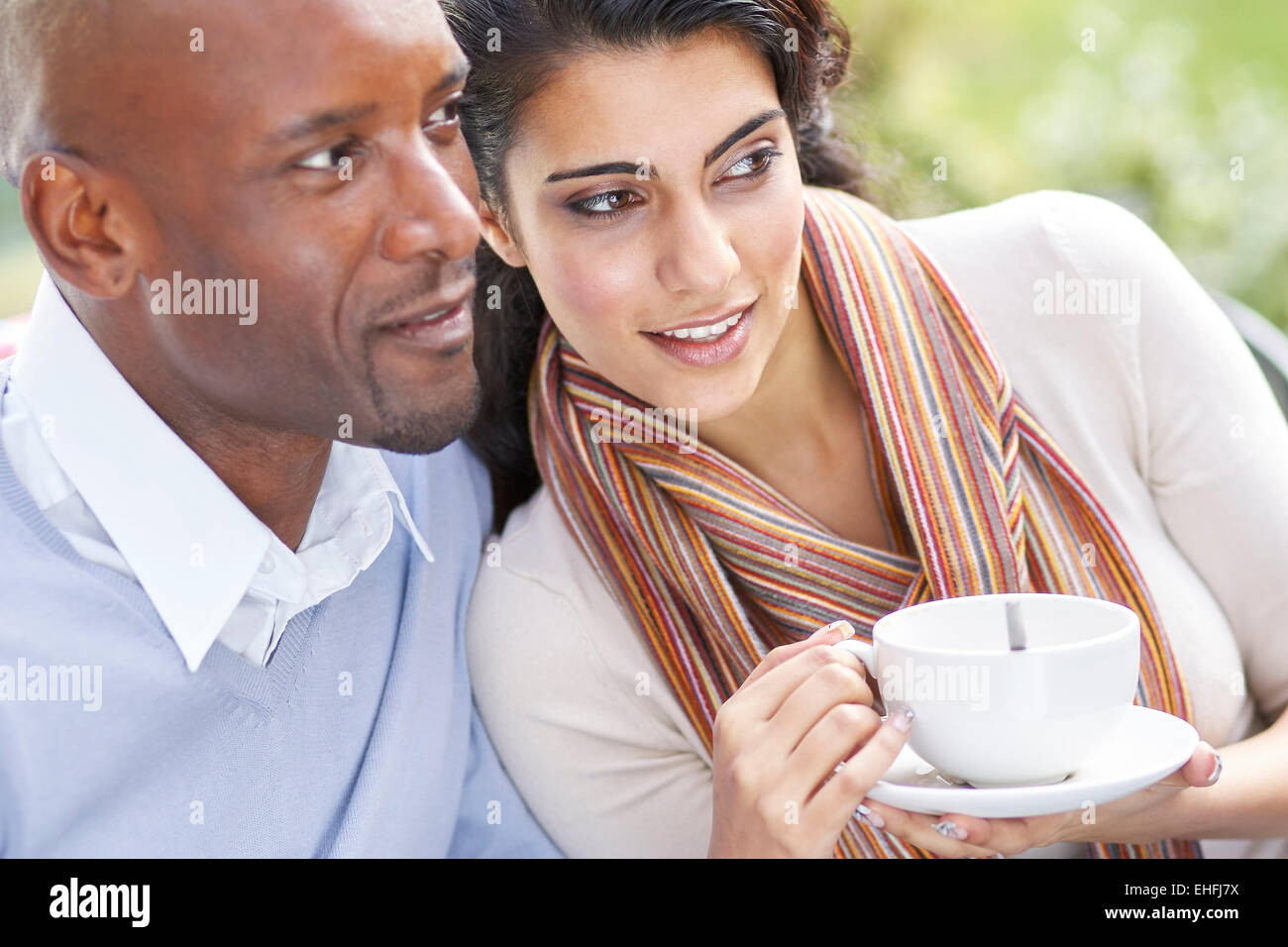 Couple relaxing outdoors drinking coffee Stock Photo - Alamy