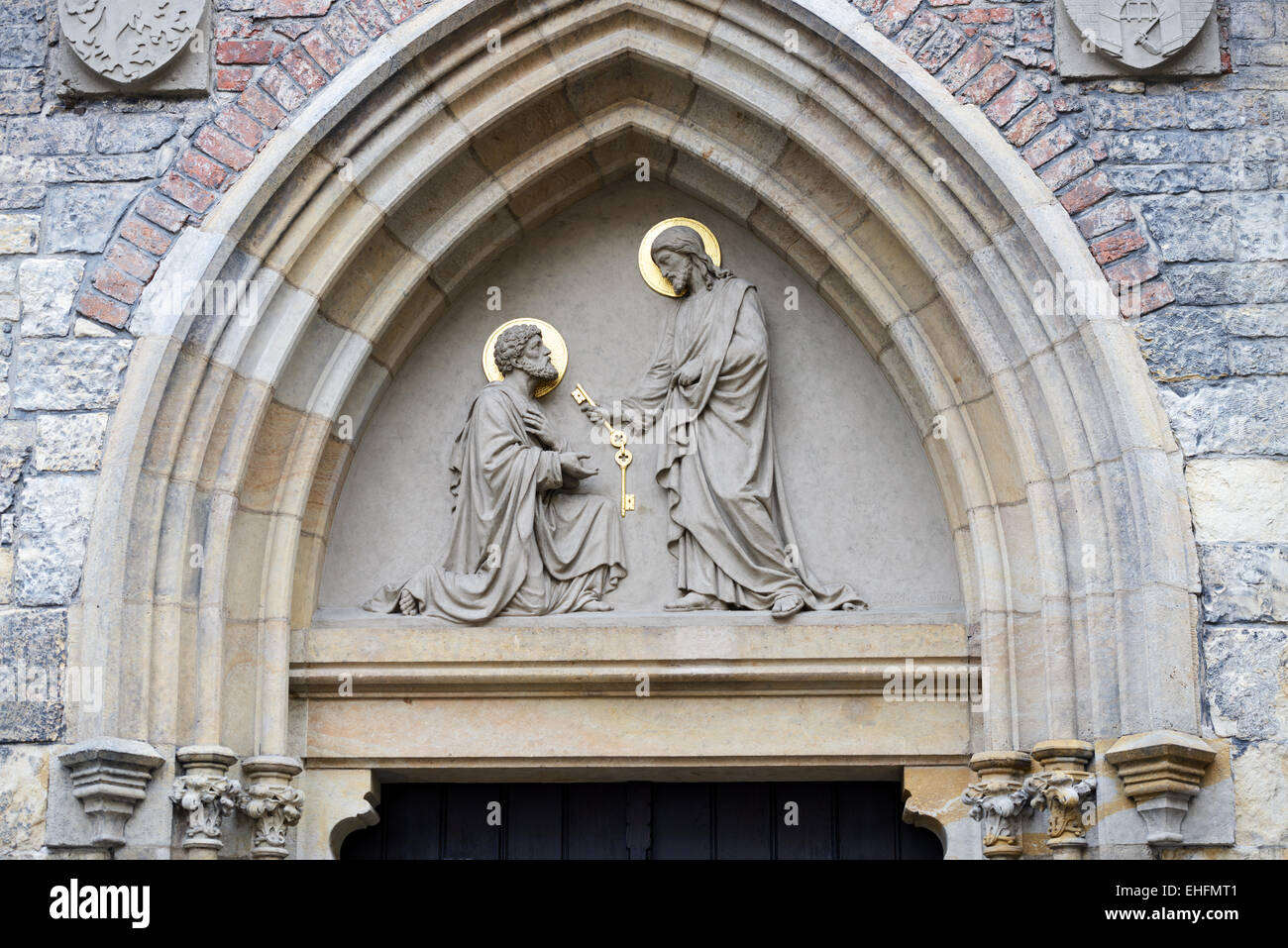 Christ hands over the keys to St. Peter. Sculpture on top of arch above ...