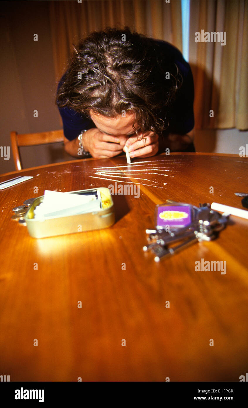 Person snorting cocaine from dining table in their home Stock Photo - Alamy