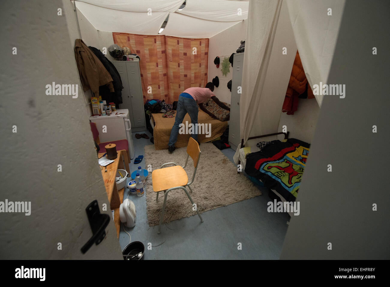A refugee straightens his bed at the refugee accommodation in Esslingen ...