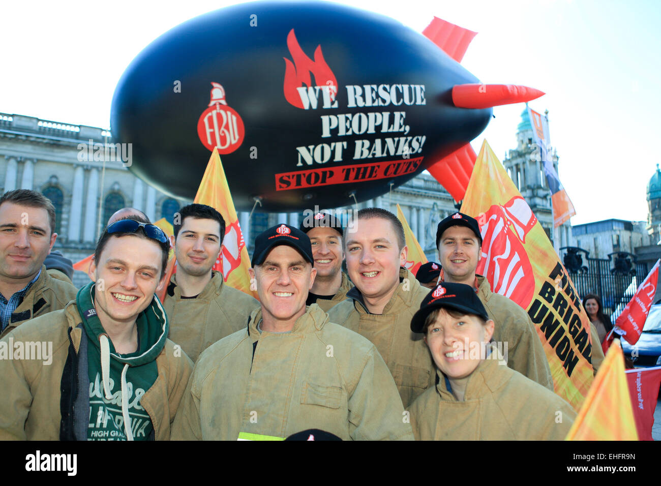 Belfast, UK. 13th March, 2015. Firemen below a Fire Service Union blimp ...