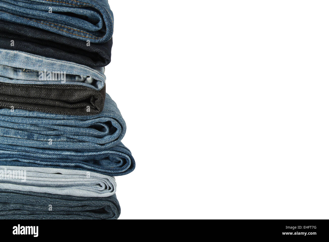 A pile of jeans on a white background Stock Photo - Alamy
