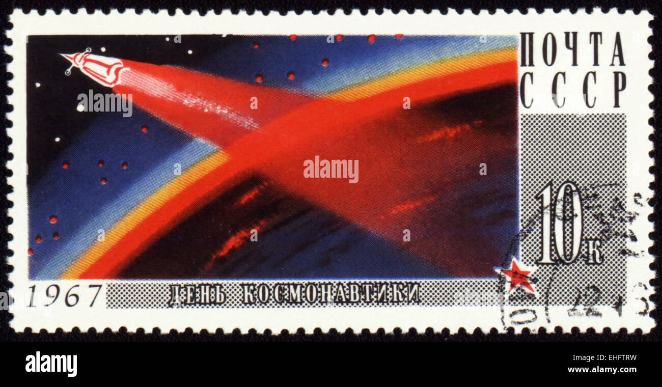 USSR - CIRCA 1967 A stamp printed in USSR shows rocket on Earth orbit ...