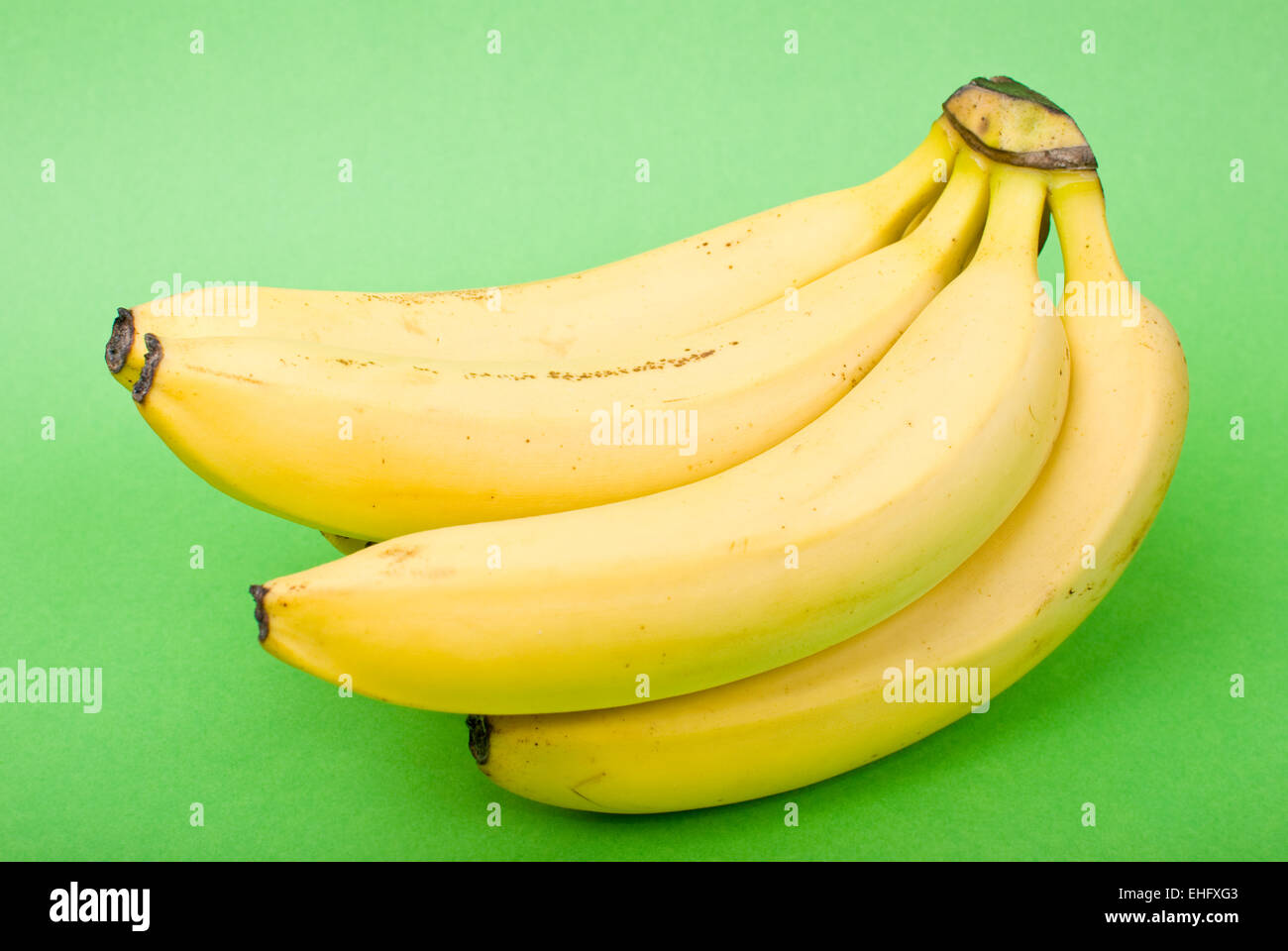 Ripe banana bunch on green background Stock Photo - Alamy