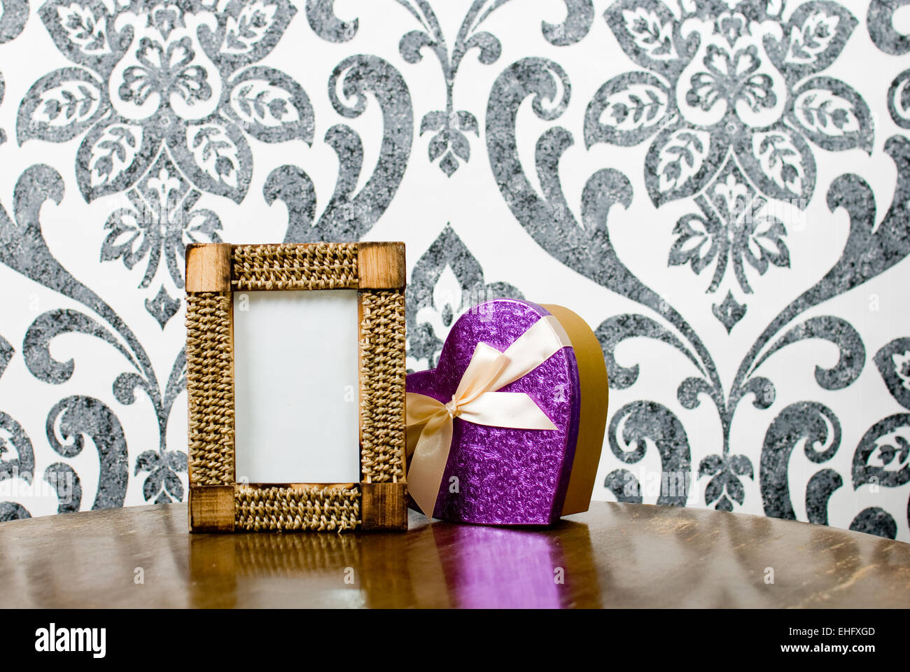 Wooden photo frame and present box on table Stock Photo - Alamy