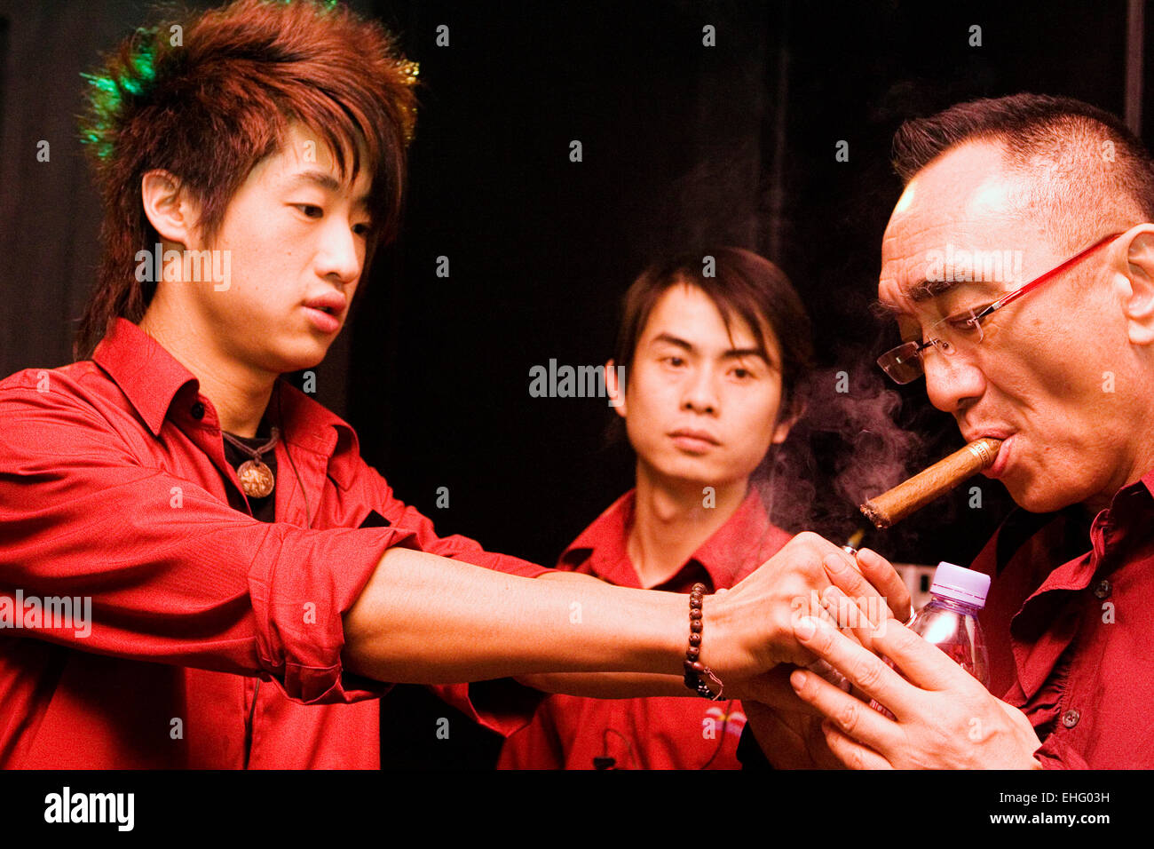 Gentlemen having his cigar lit by waiting staff at the Paramount club ...