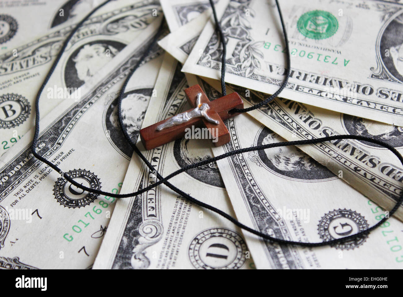 wooden cross on the background from dollar banknotes Stock Photo - Alamy