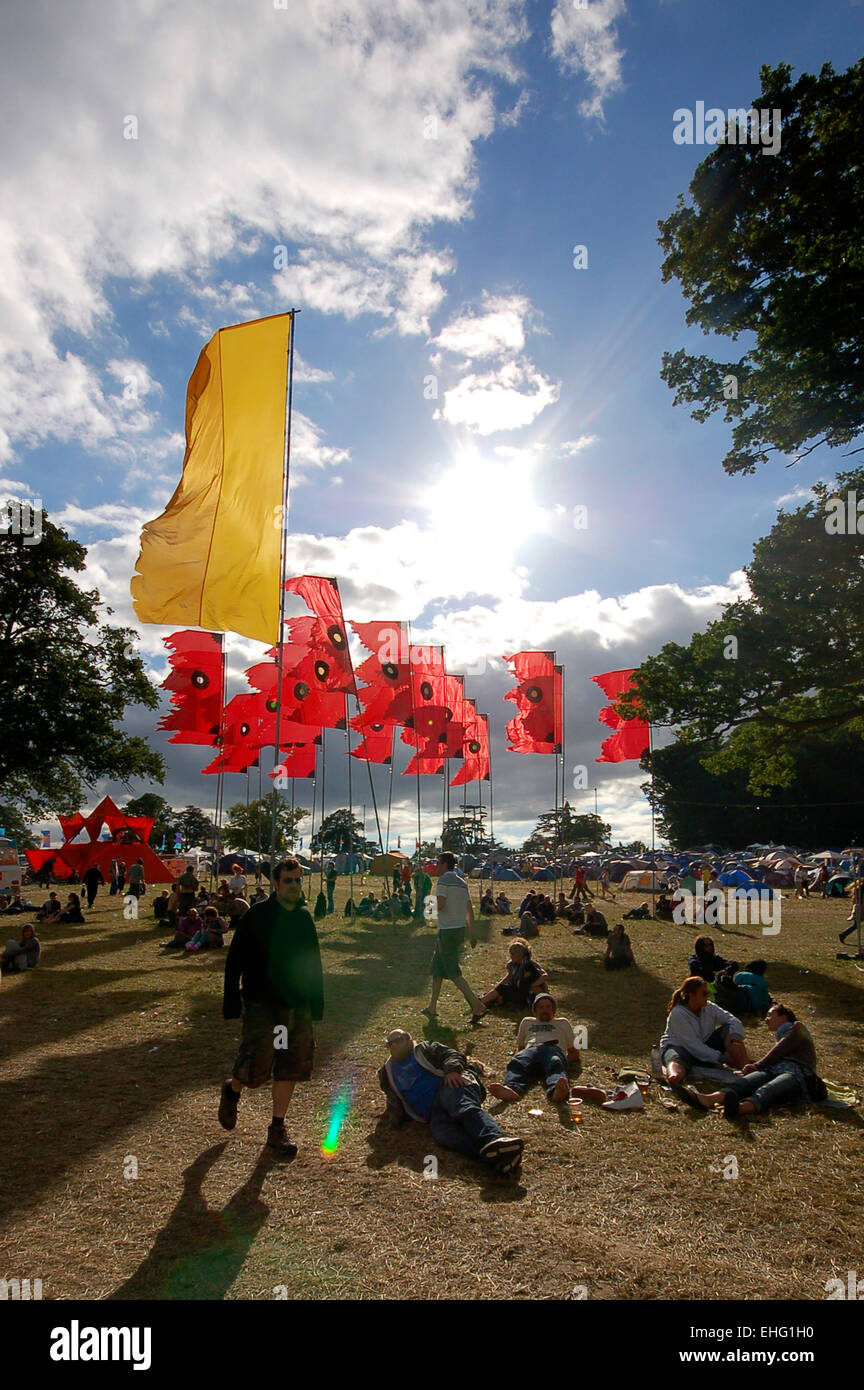 Wide shot of the sun setting behind coloured flags at the Glade ...