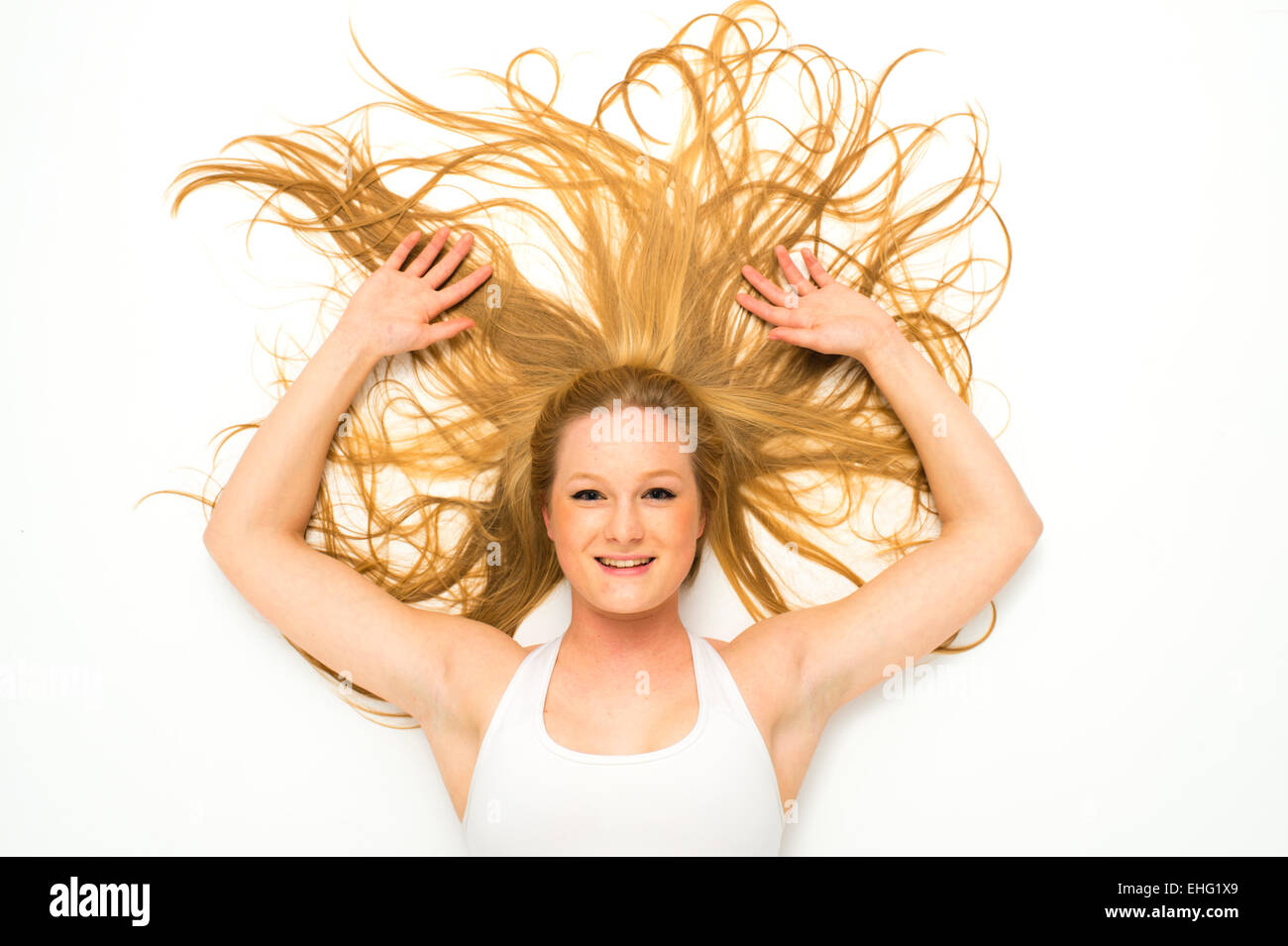 A young woman 19 year old teenage girl viewed from above lying on her ...