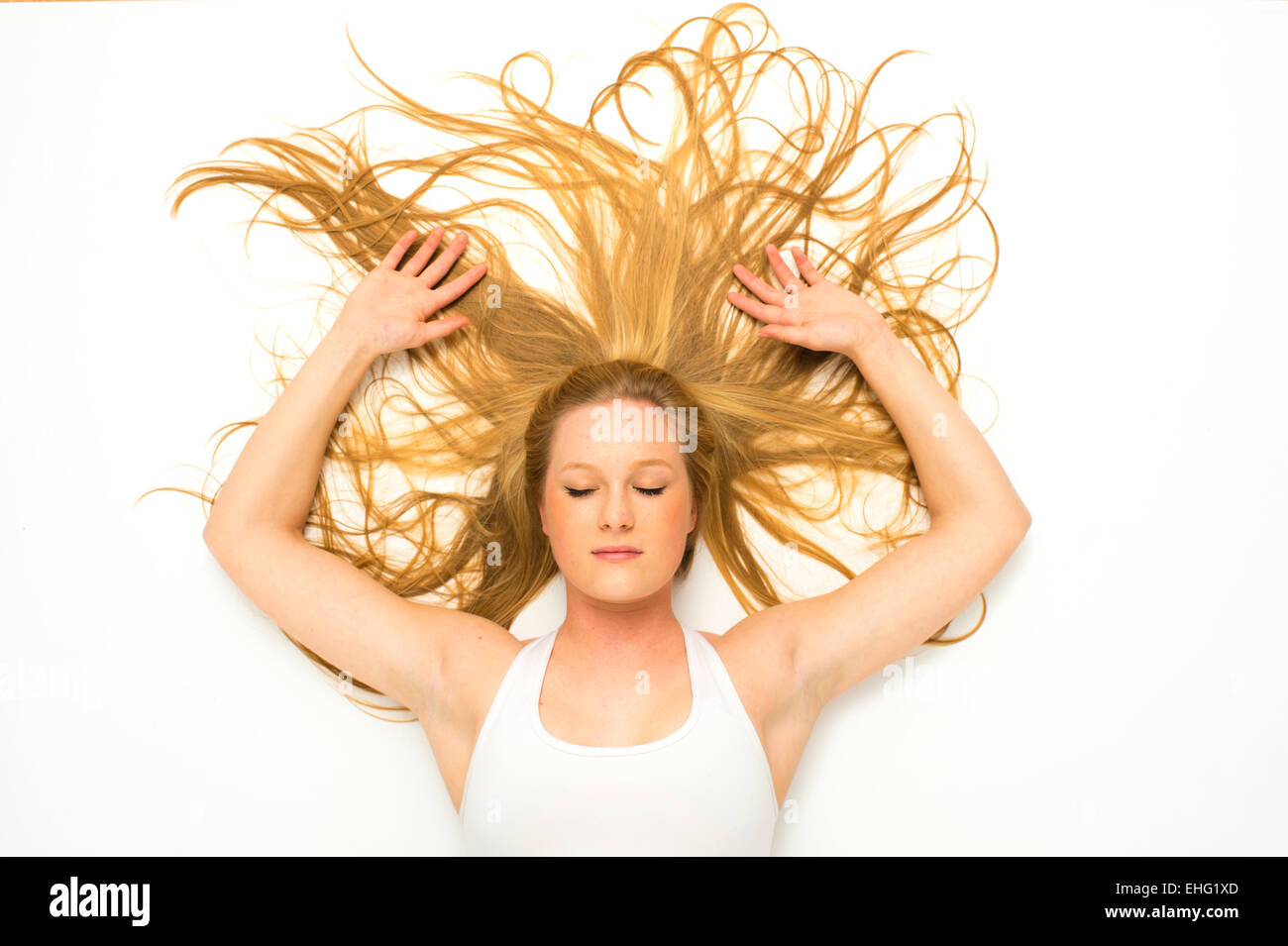 A young woman 19 year old teenage girl viewed from above lying on her ...