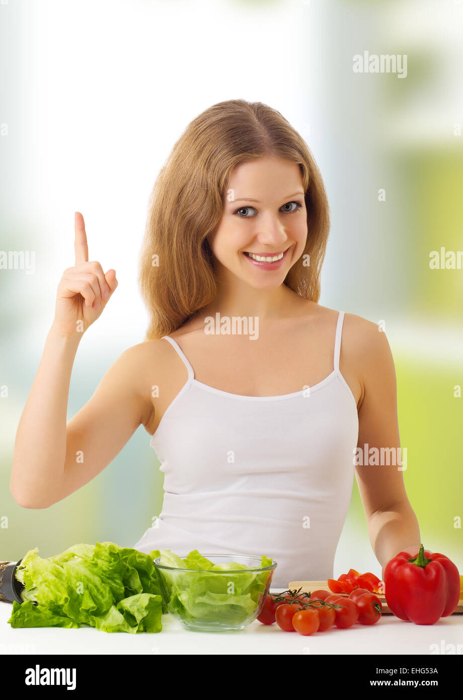 beautiful girl with vegetables in the kitchen Stock Photo - Alamy