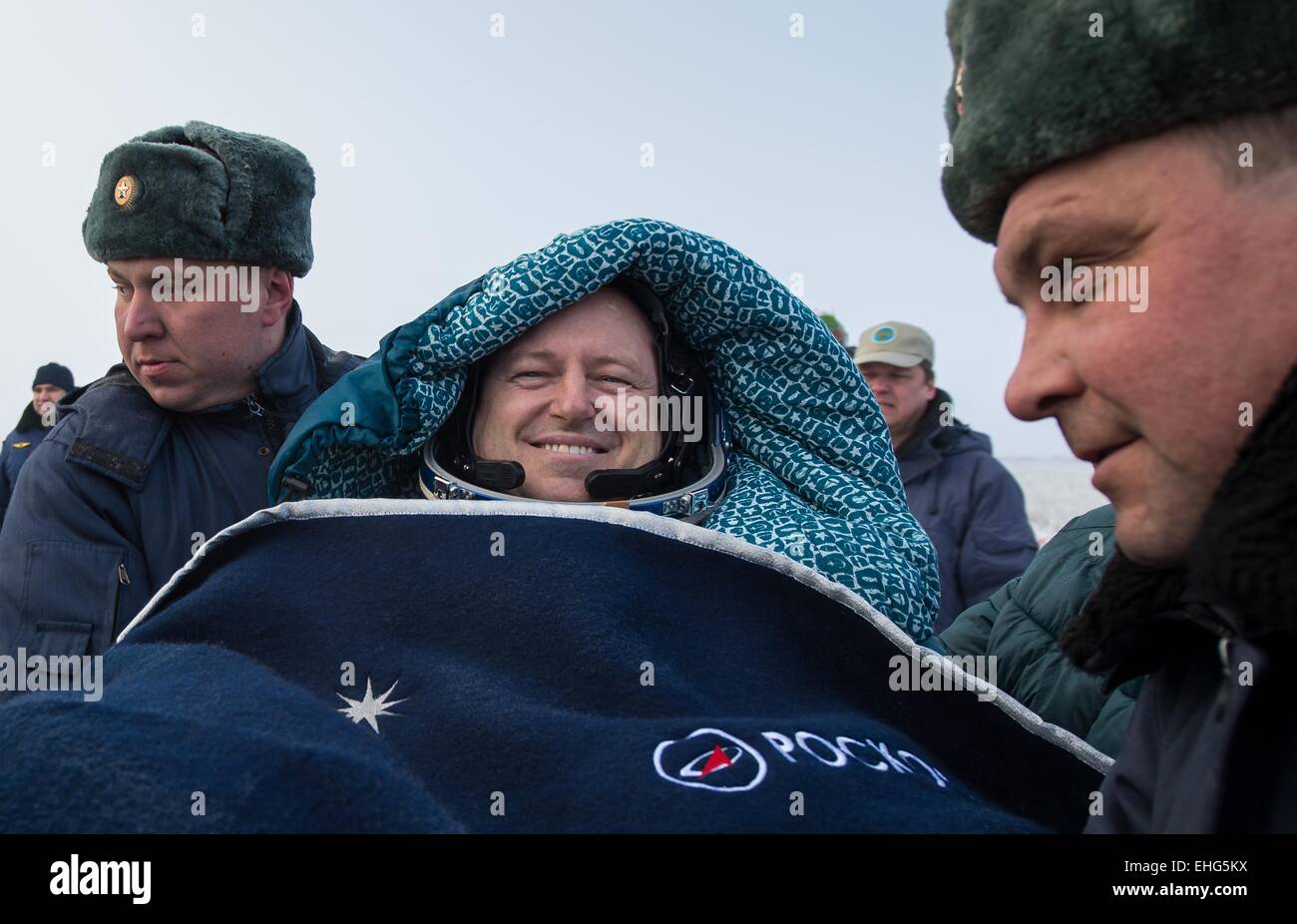 ISS Expedition 42 commander Barry Wilmore of NASA, wrapped in a blanket ...