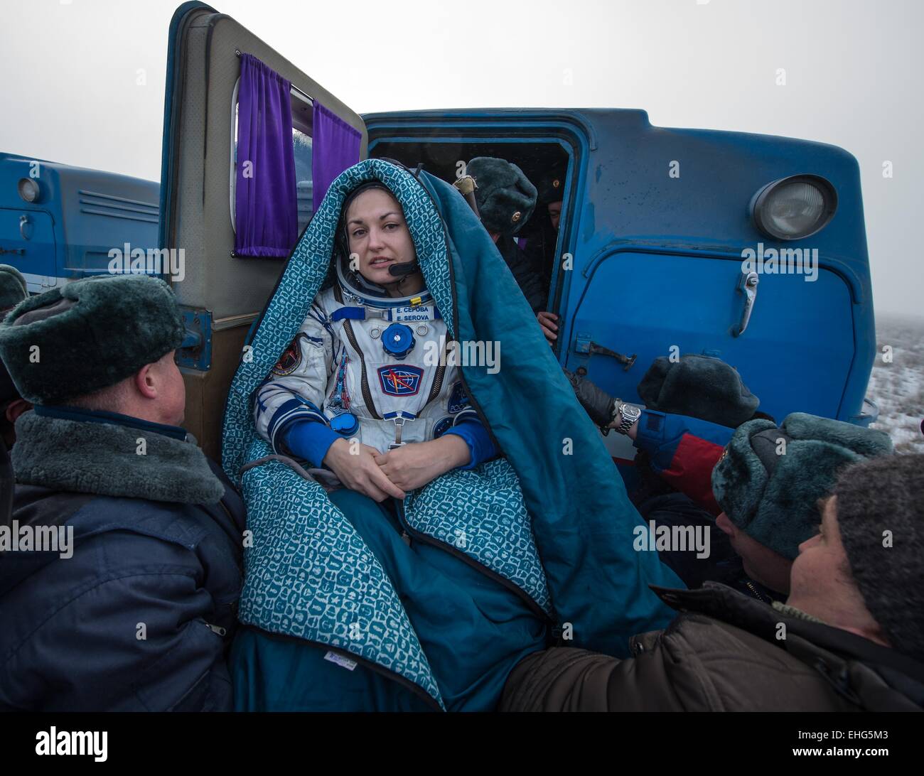 ISS Expedition 42 Cosmonaut Elena Serova wrapped in a blanket is ...