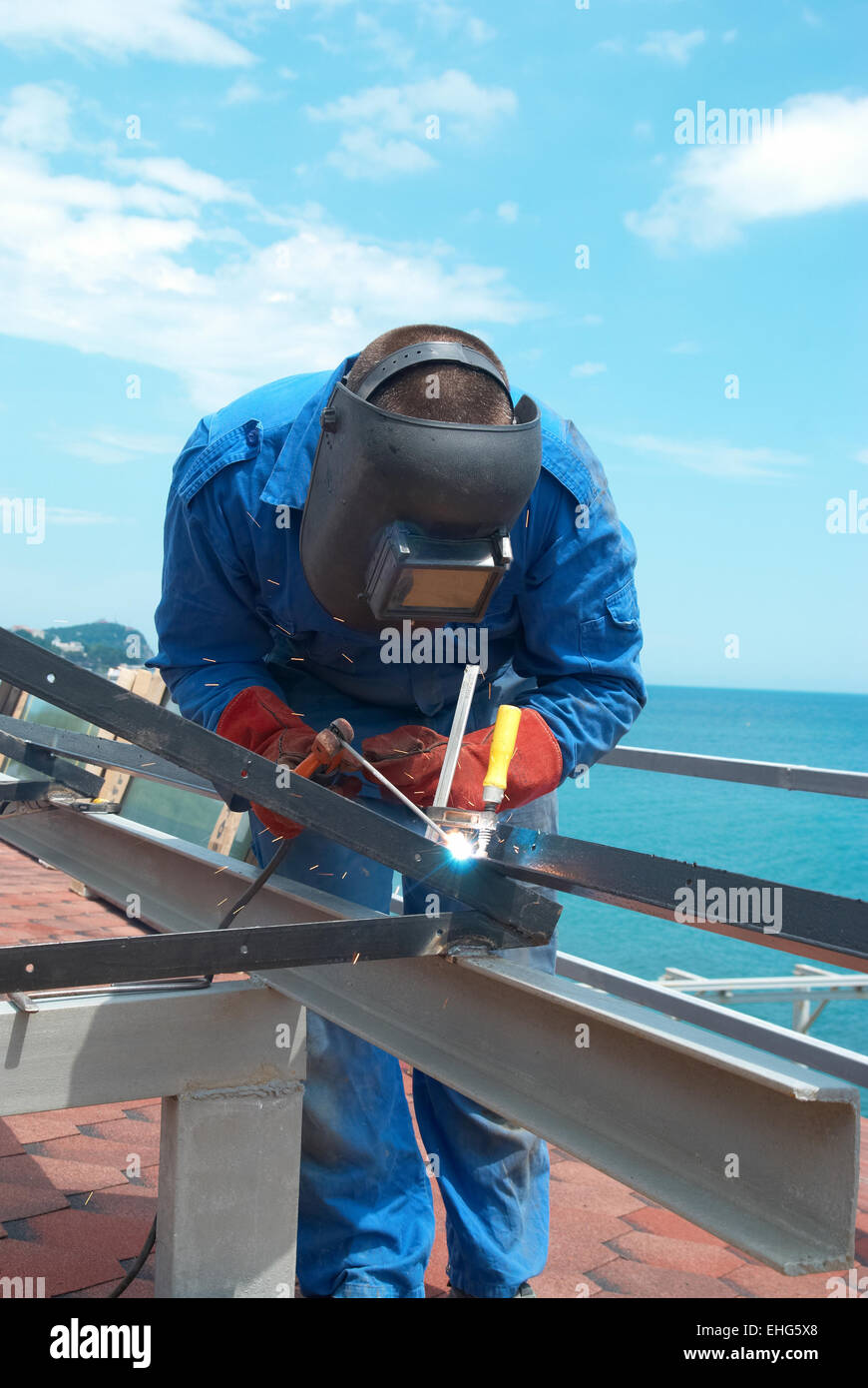 Welder working with metal construction Stock Photo - Alamy
