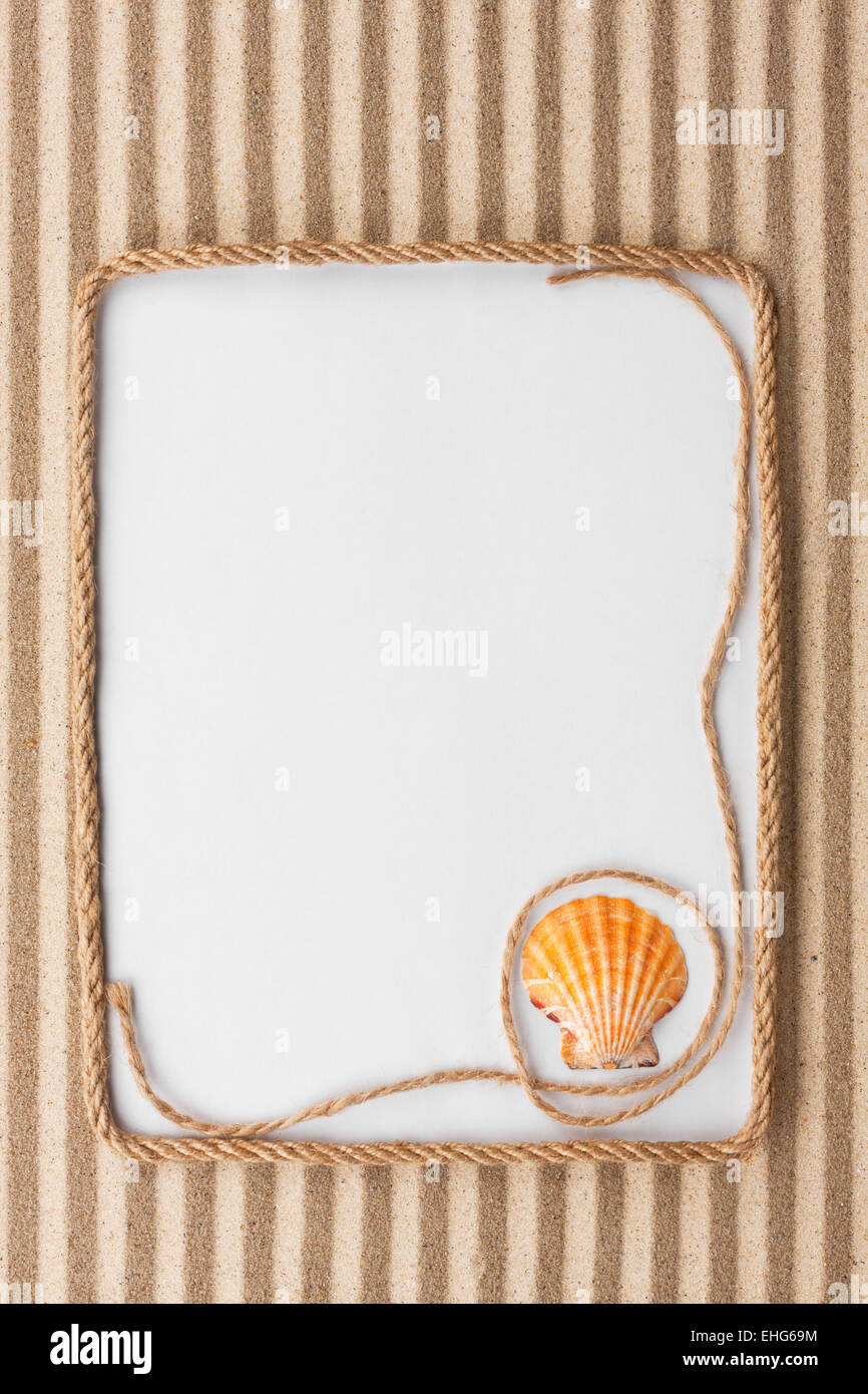 Beautiful frame of rope and sea shells with a white background on the ...