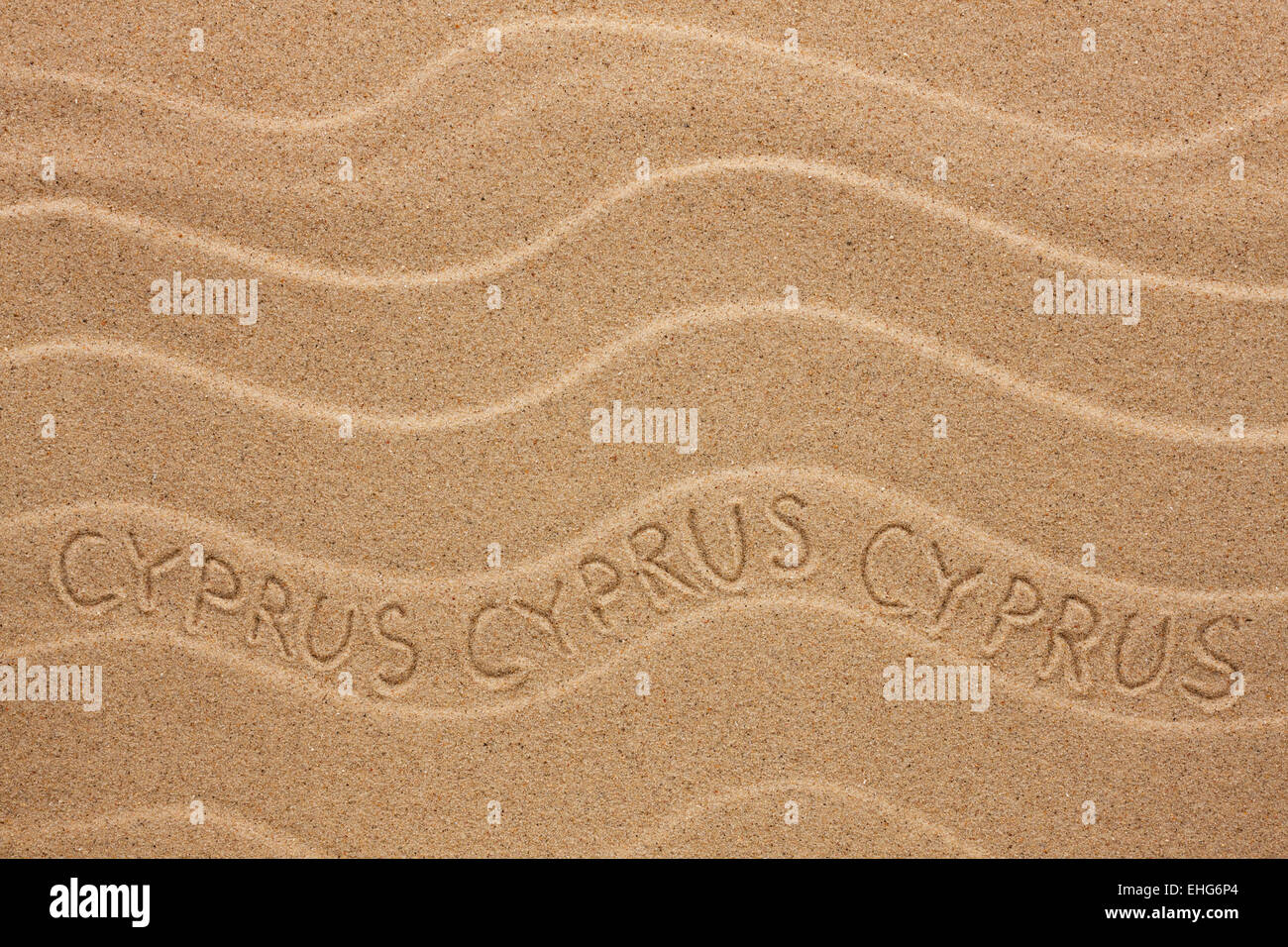Cyprus inscription on the wavy sand, as background Stock Photo - Alamy