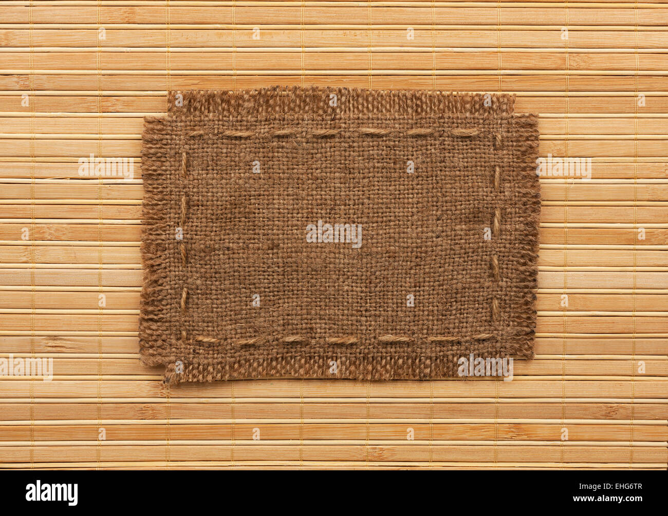 Frame of burlap, lies on a background of bamboo mat, with place for ...