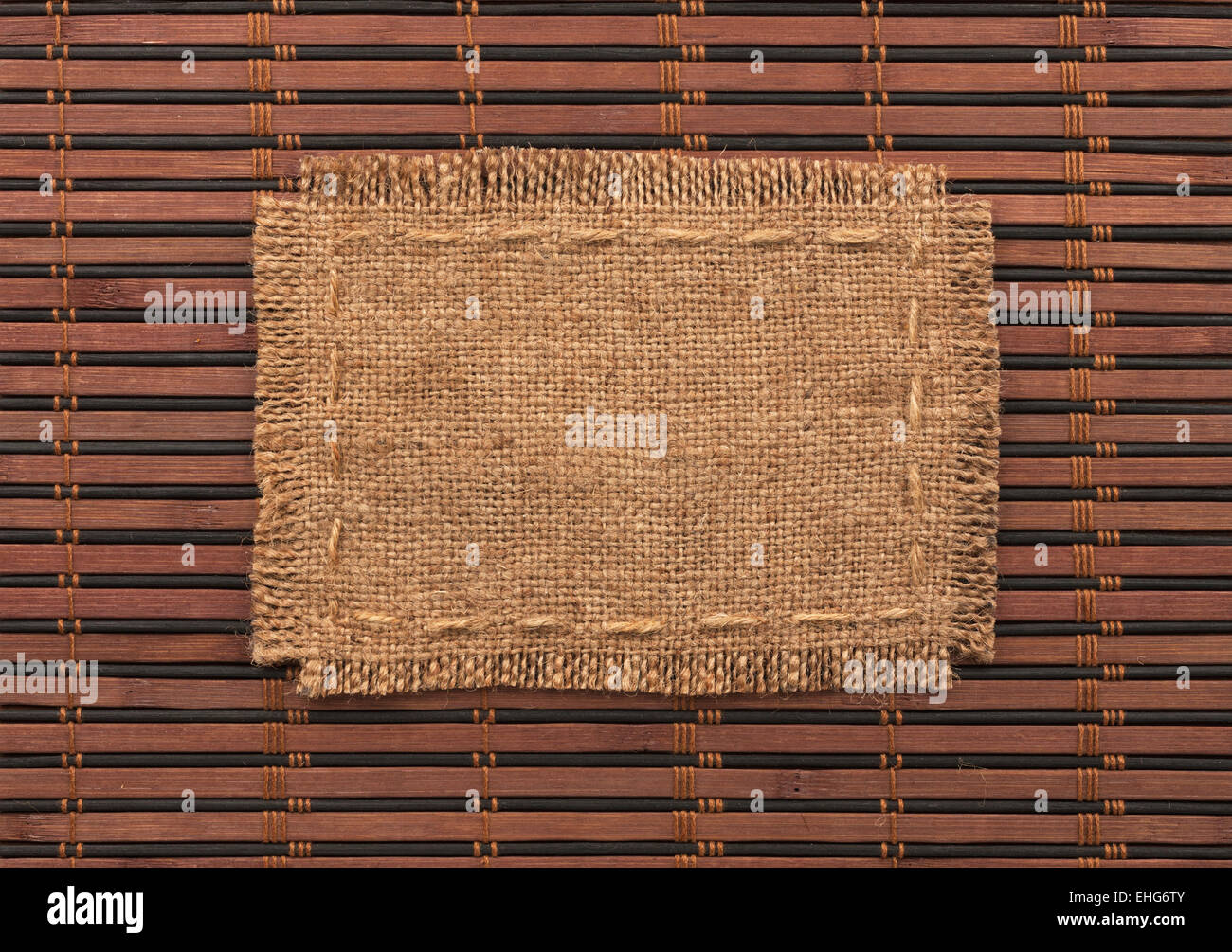 Frame of burlap, lies on a background of bamboo mat, with place for ...