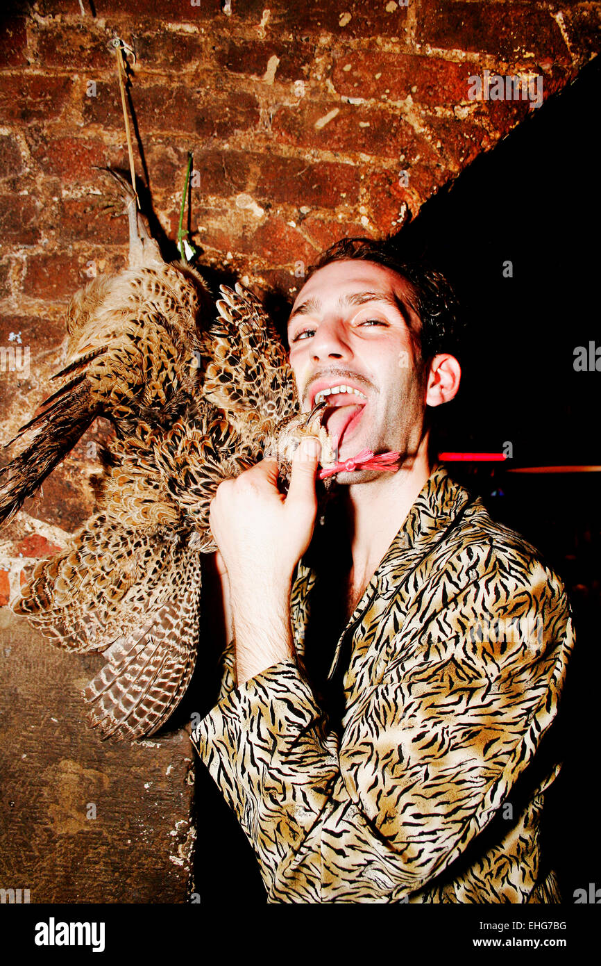 Guy licking a pheasants foot at The Last Tuesday Society's ' A Danse ...