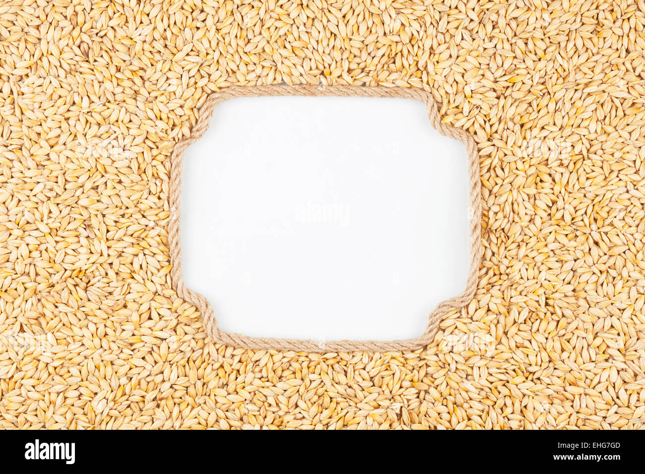 Figured frame made of rope with barley grains lying on a white ...