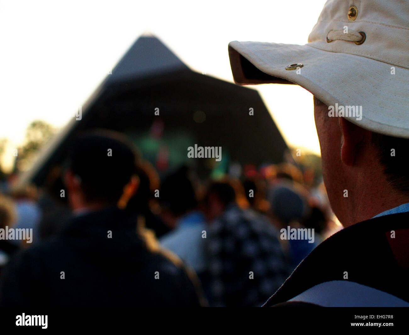 Man in hat watching the Pyramid stage at Glastonbury 2008 Stock Photo ...