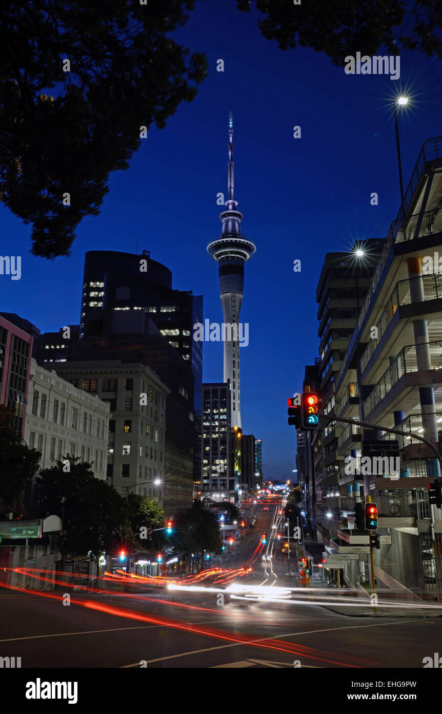 Vehicles pass the Sky Tower in Auckland's central business district on ...