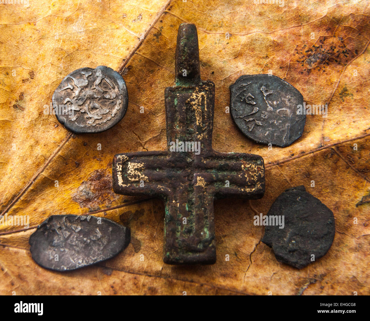 medieval Christian cross Copper and silver coins on the background of ...