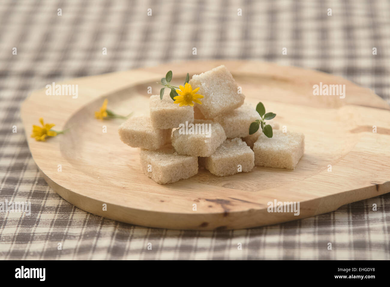 Brown sugar cube on wooden plate Stock Photo - Alamy