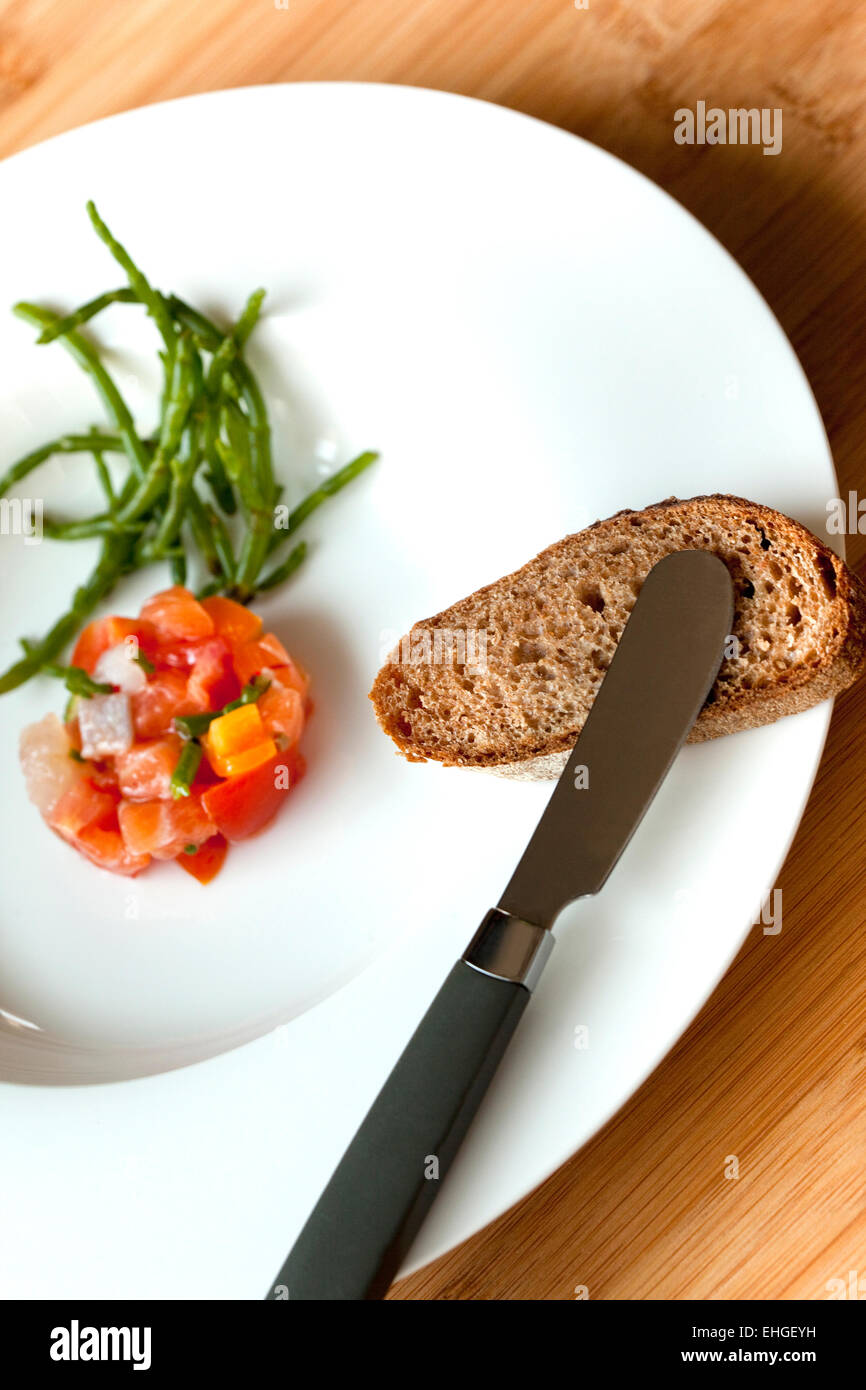 Fish tartare, salicornia and slice of bread on a plate Stock Photo - Alamy
