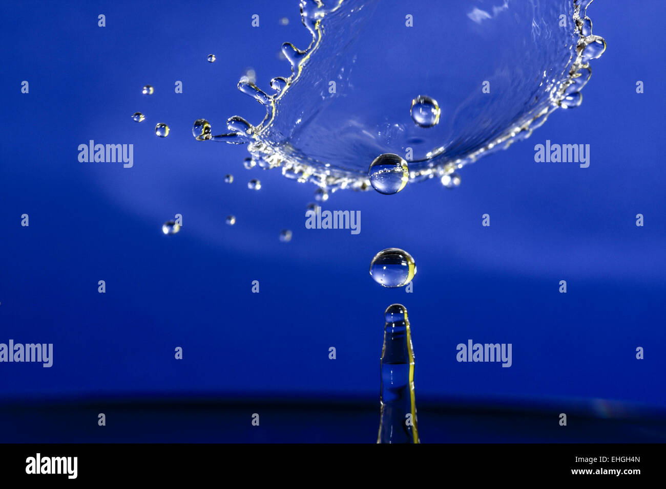 Water drop collisions with a blue background Stock Photo - Alamy