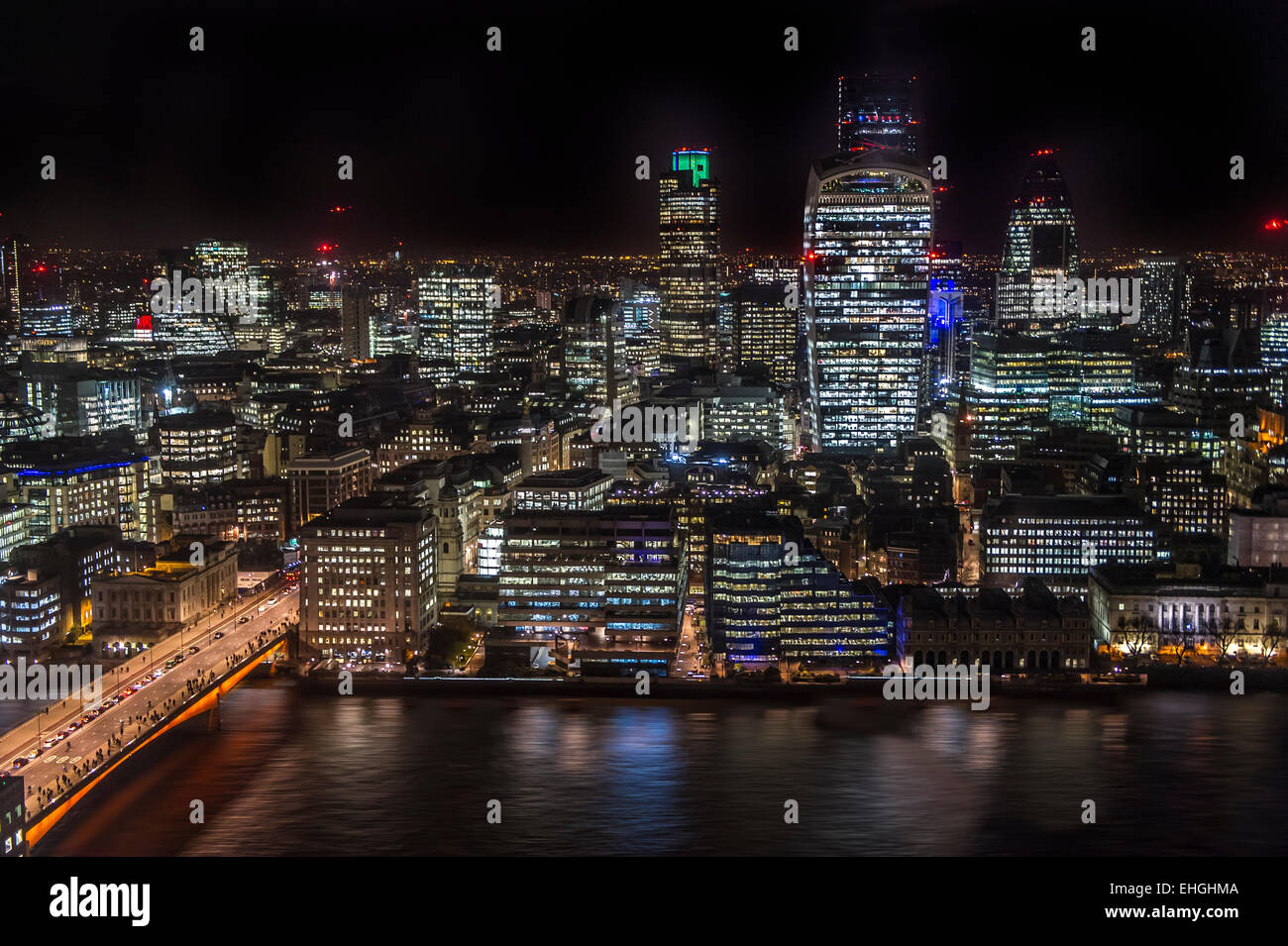 A view of the Square Mile City of London at night with the Gherkin and ...