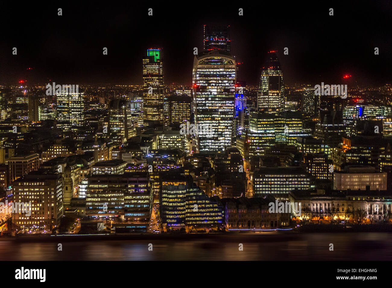 A view of the Square Mile City of London at night with the Gherkin and ...