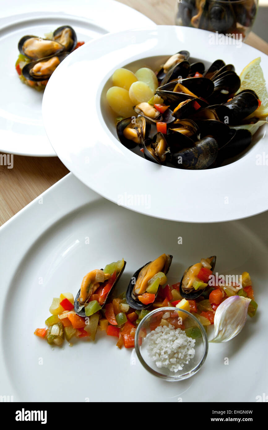 Various recipes of mussels and vegetables on plates Stock Photo - Alamy