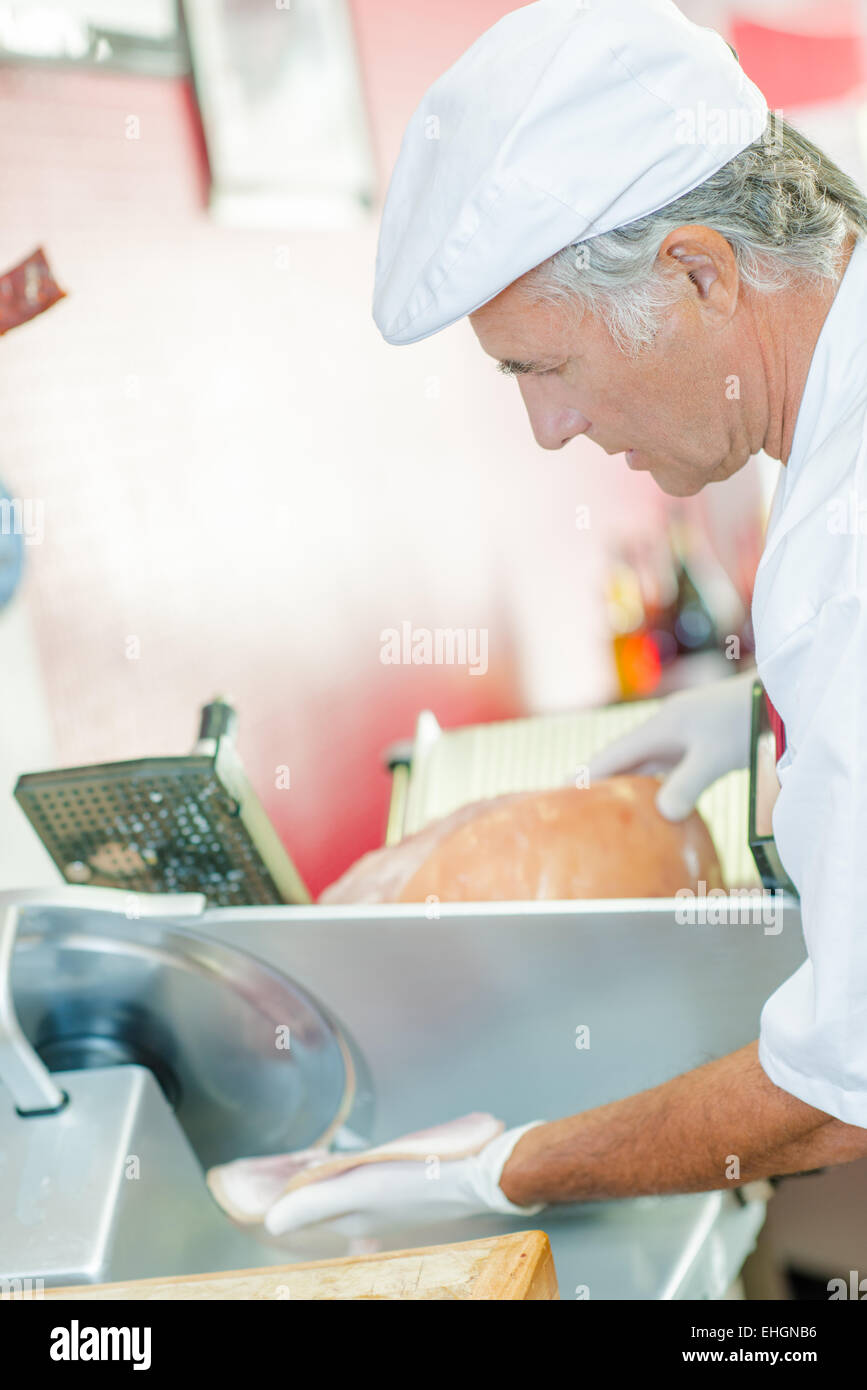 Butcher slicing ham Stock Photo - Alamy