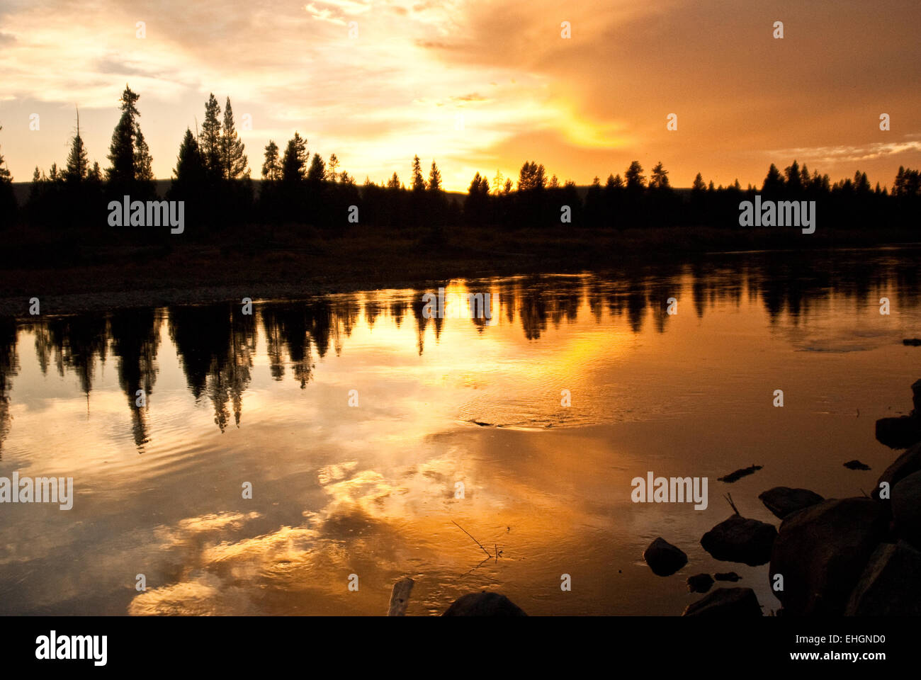 Smokey orange sunset on lake Stock Photo - Alamy