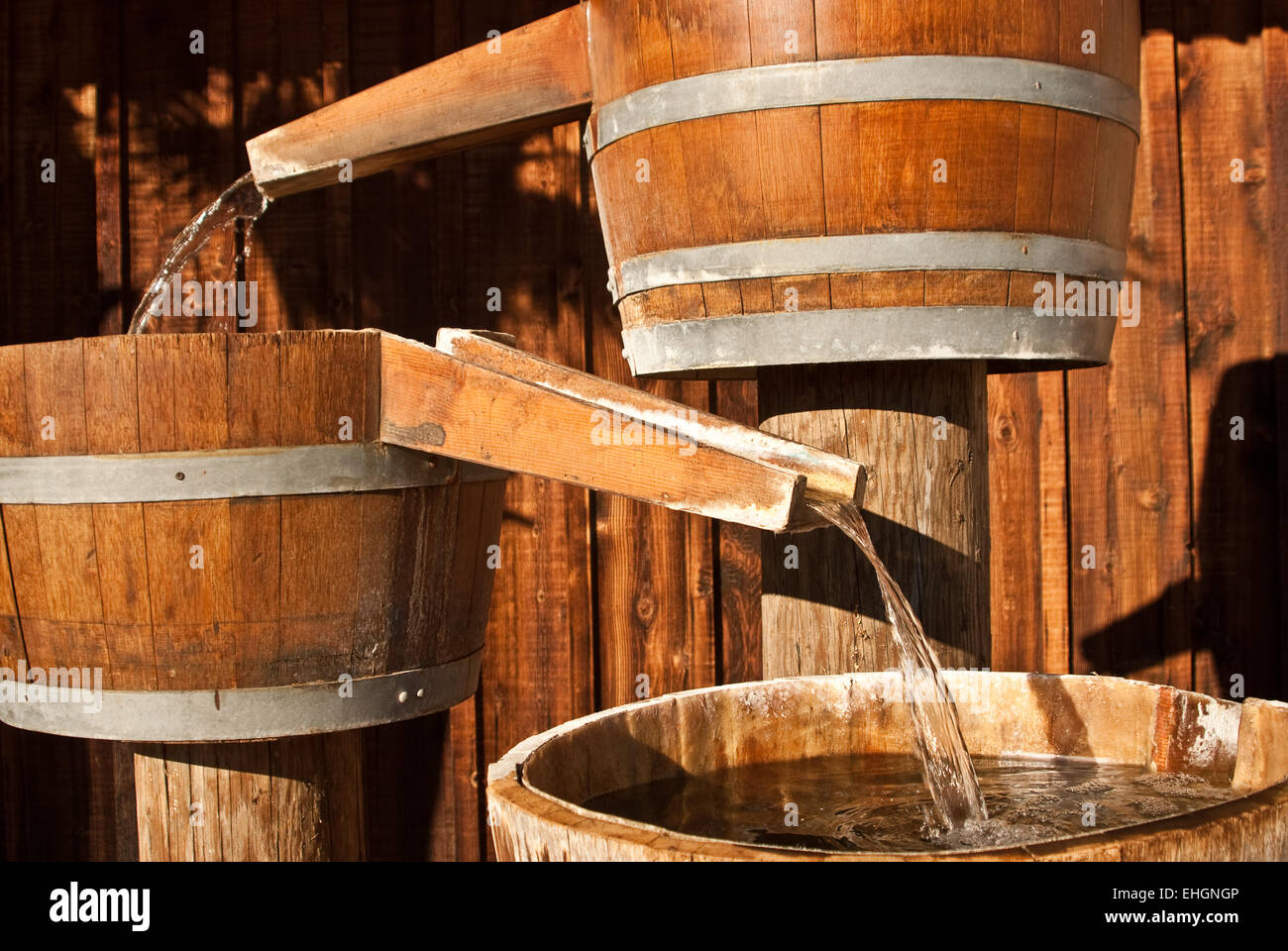 Wooden water barrels funnel cold water through chu Stock Photo - Alamy