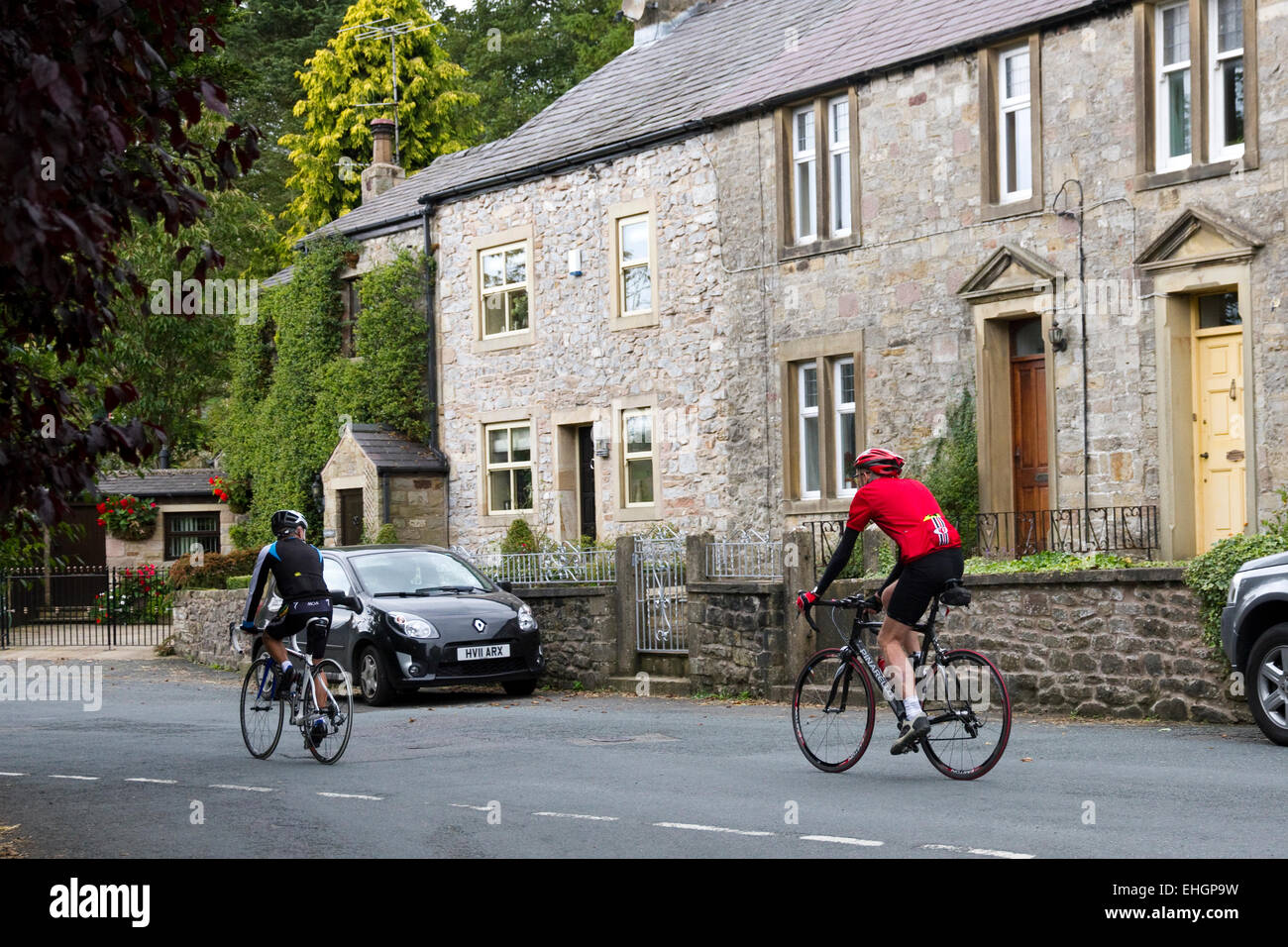Cyclists riding through village of Newton in the Forest of Bowland ...