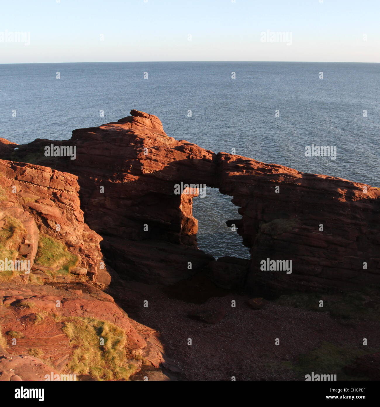 Needle E'e rock arch in red sandstone Seaton Cliffs Angus Scotland ...