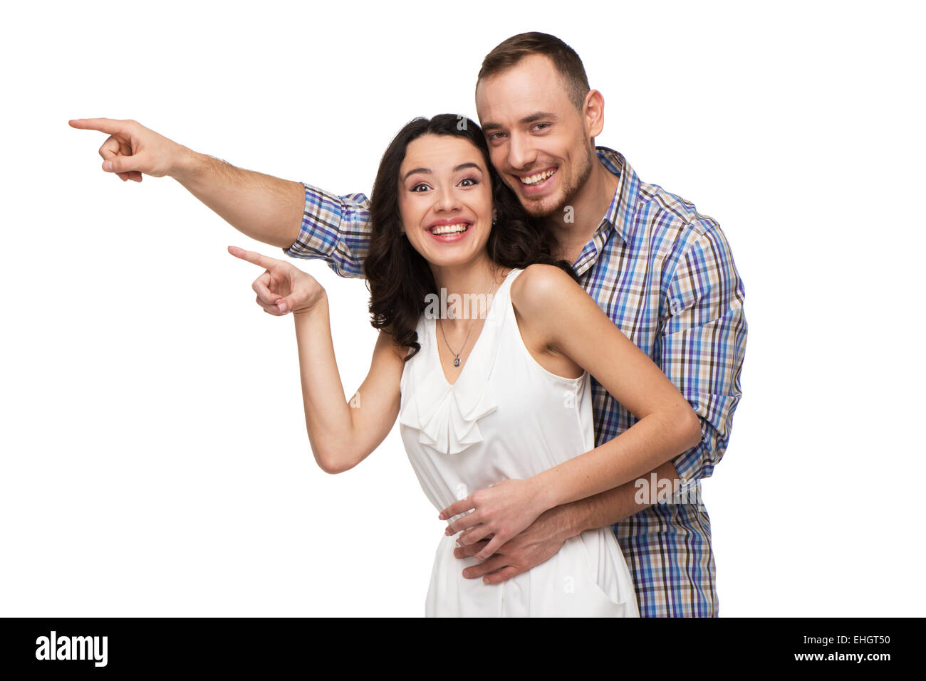 Cheerful lovers point at something Stock Photo - Alamy