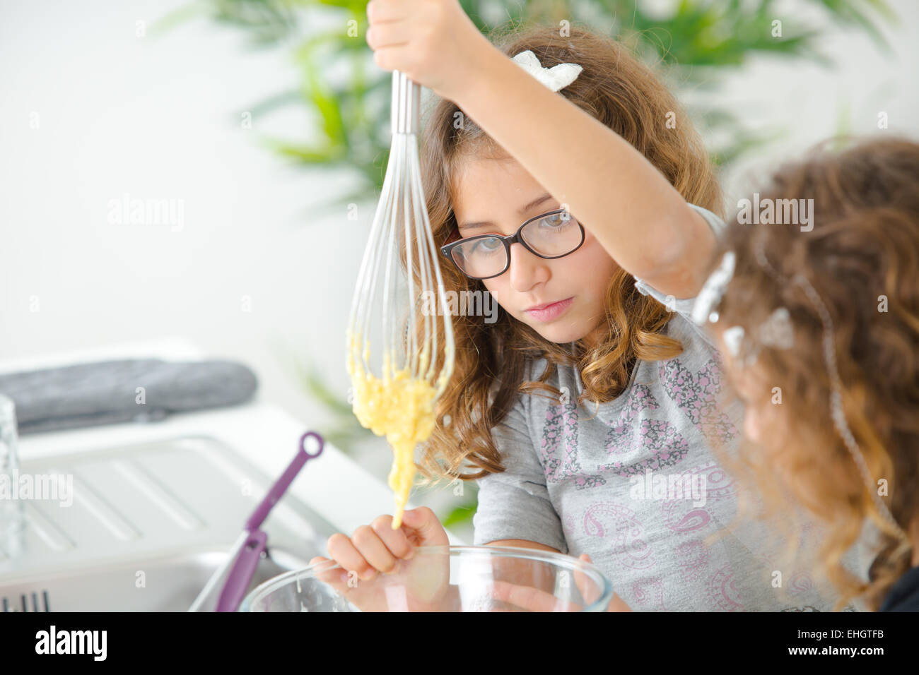 Two sisters baking Stock Photo - Alamy