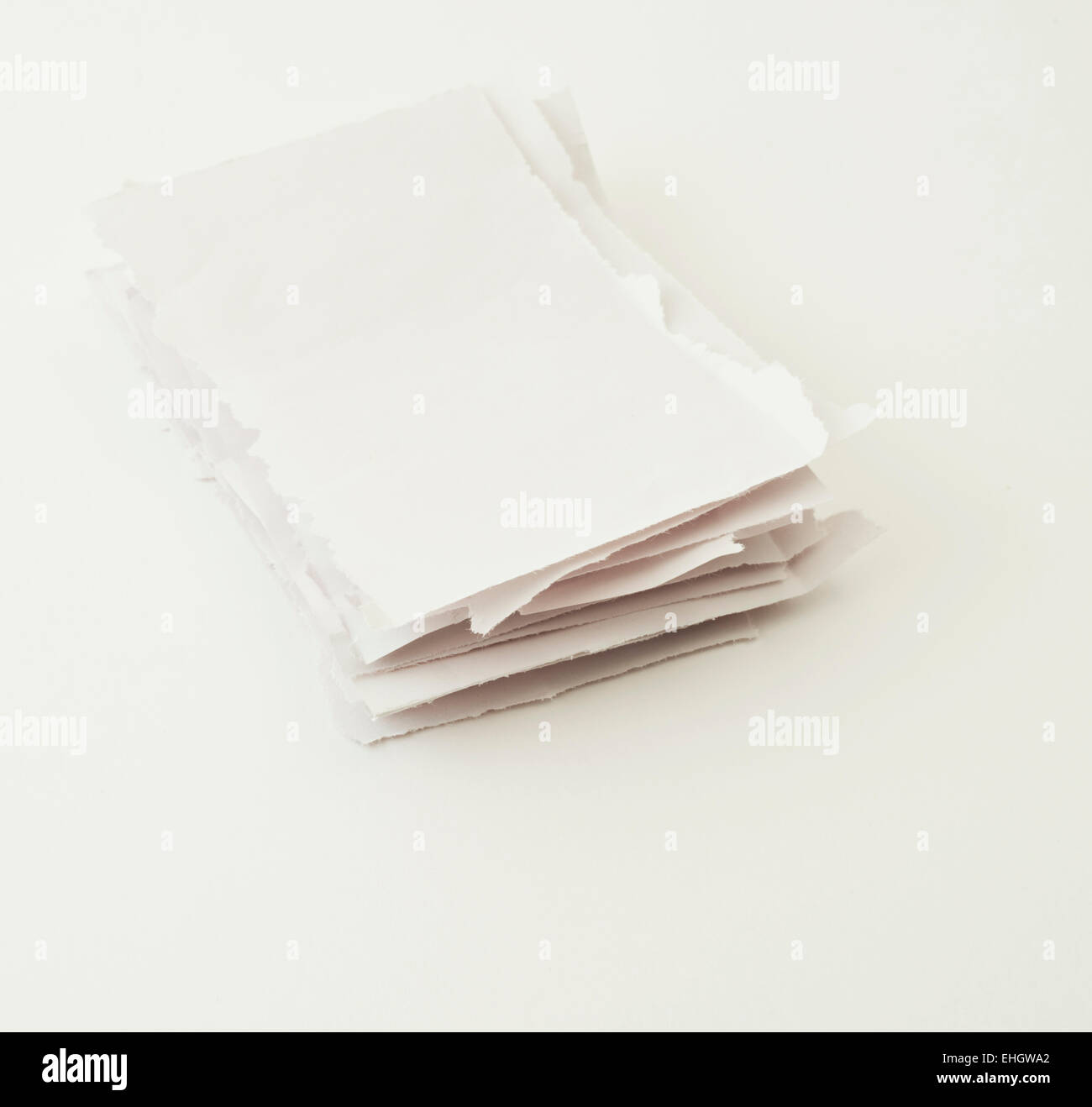 Stack of torn paper pieces over white Stock Photo - Alamy