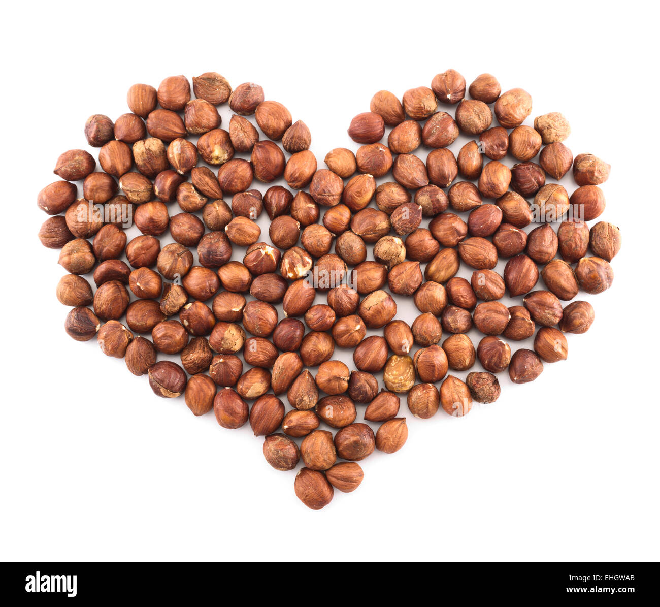 Heart shape made of hazelnuts isolated Stock Photo - Alamy