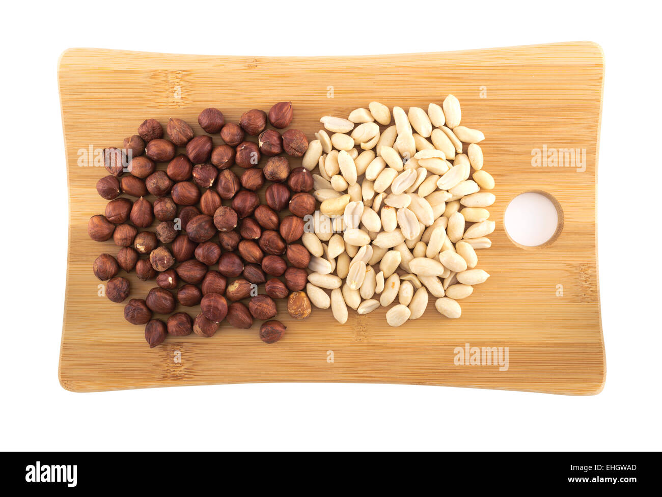 Wooden cutting board covered with nuts Stock Photo - Alamy