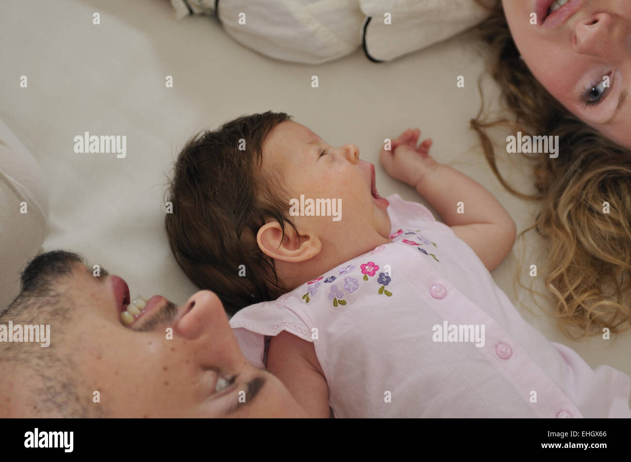 young family playing with cute little baby Stock Photo - Alamy
