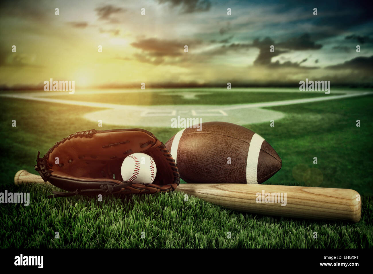 Baseball, bat, and mitt in field at sunset Stock Photo - Alamy