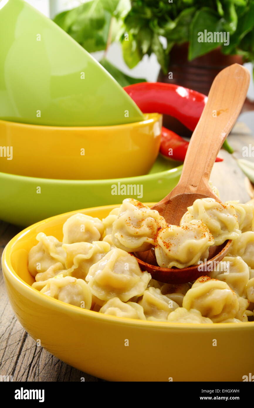 Dumplings in a bowl and wooden spoon Stock Photo - Alamy